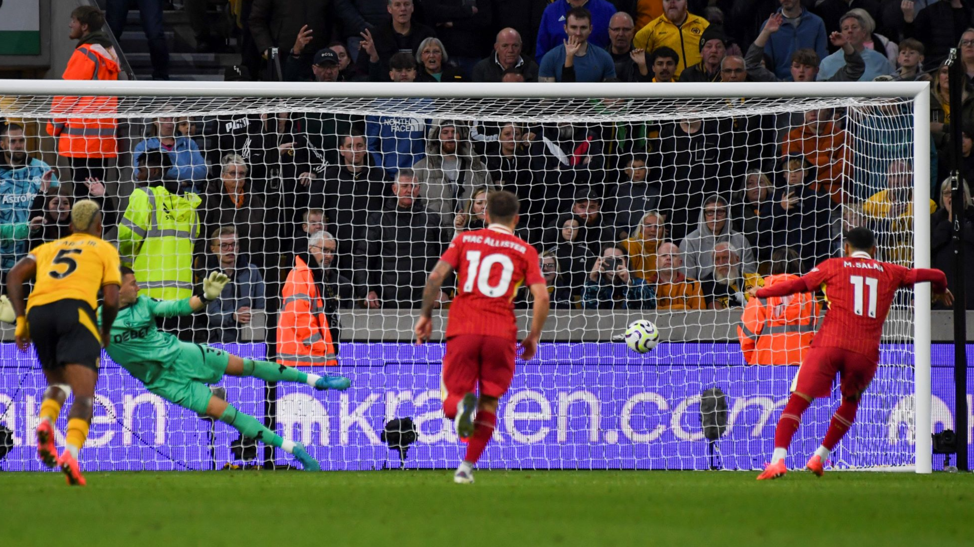 Liverpool go top of Premier League with 2-1 win over hapless Wolves
