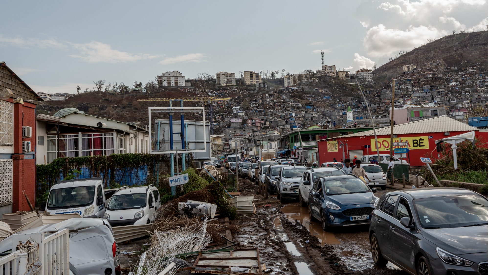 Angry residents of cyclone-hit Mayotte jeer Macron, plead for water
